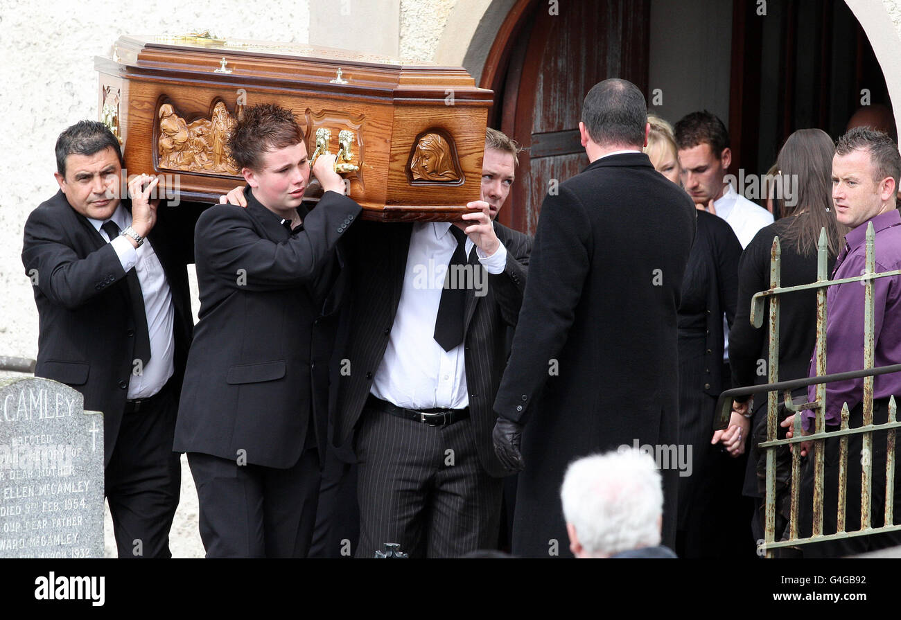 The coffin of Marian Graham is carried by family members at her funeral ...