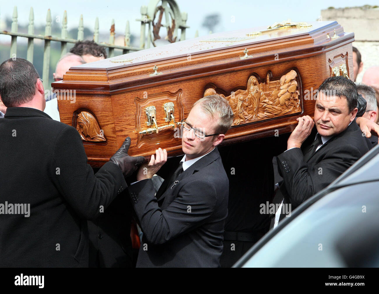 The coffin of Marian Graham is carried by family members into St Mary's ...