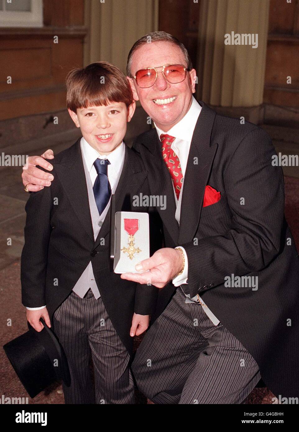Songwriter Leslie Reed and his grandson Alex, aged 8, with his OBE ...