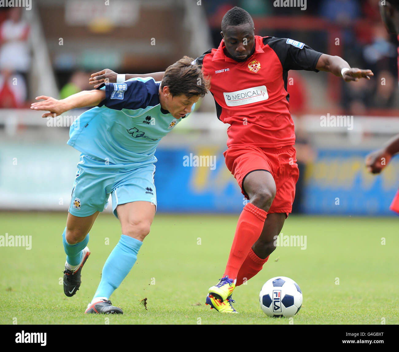 Cambridge United's Tom Shaw (left) and Kettering Town's Moses Ashikodi ...
