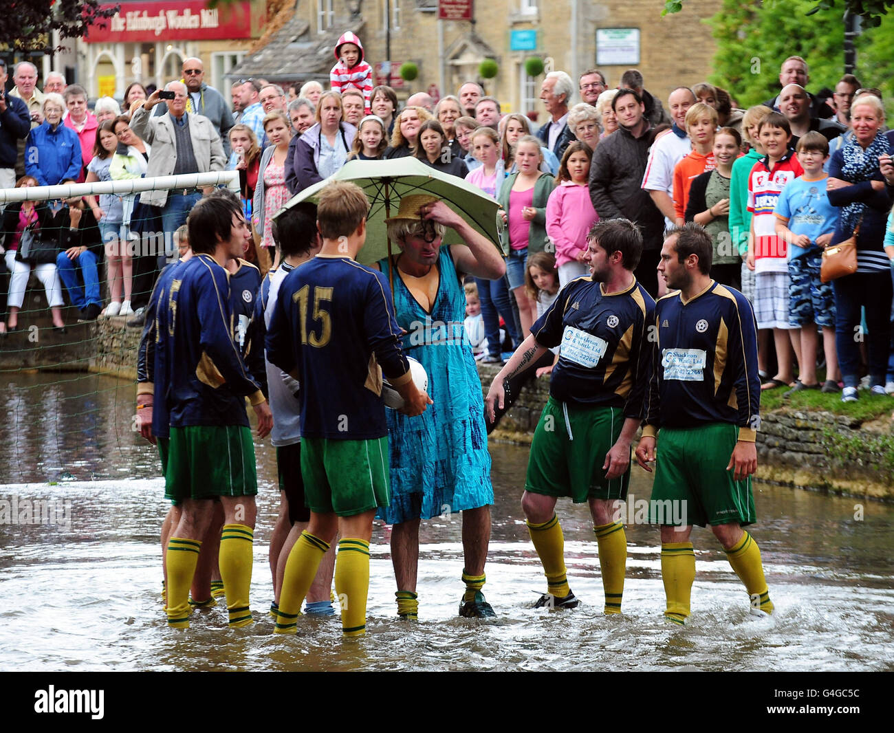 The referee (centre, with umbrella) explains the match rules to one of ...