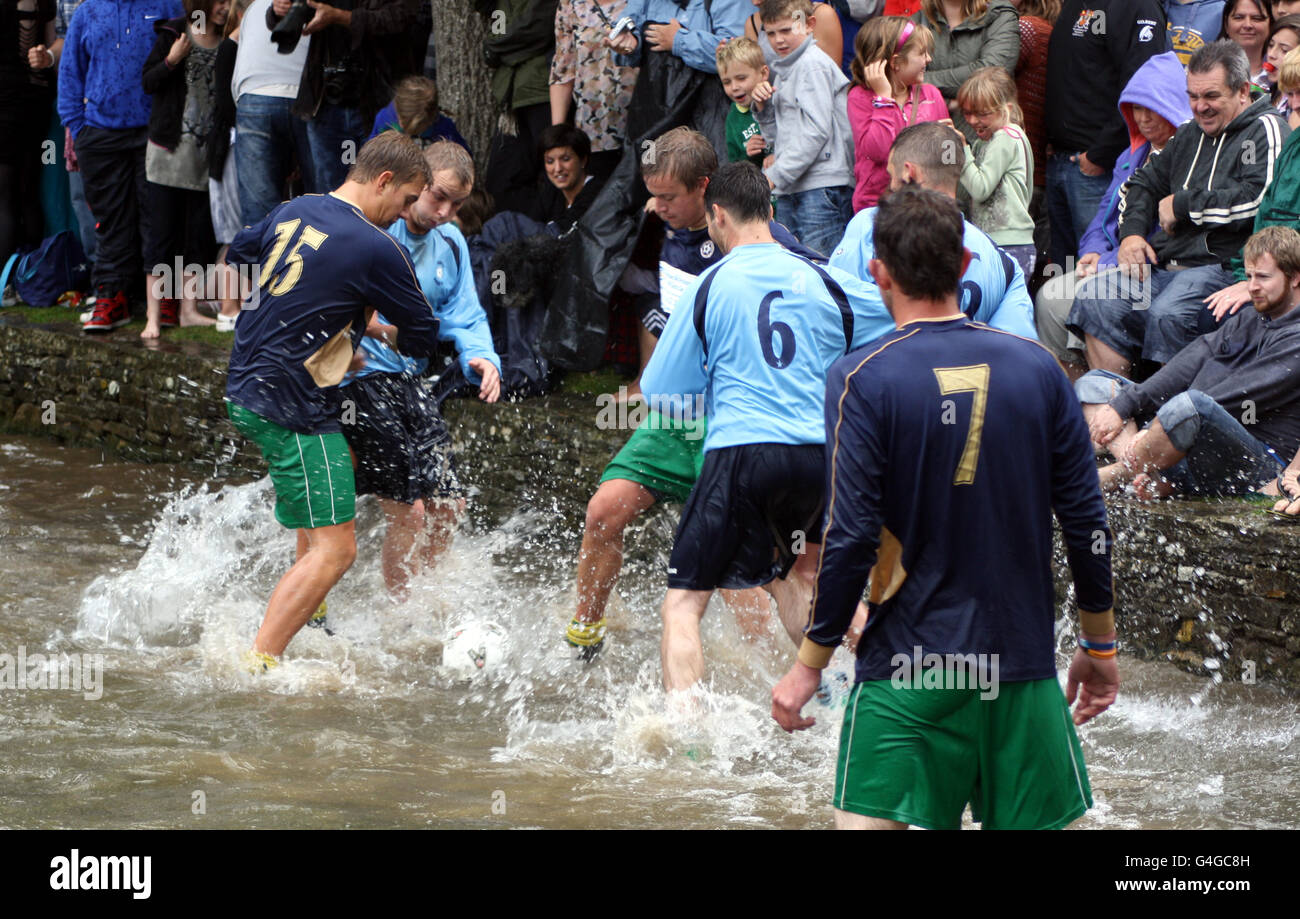 Bourton Rovers 1st XI (light blue) battle for possession with Bourton ...