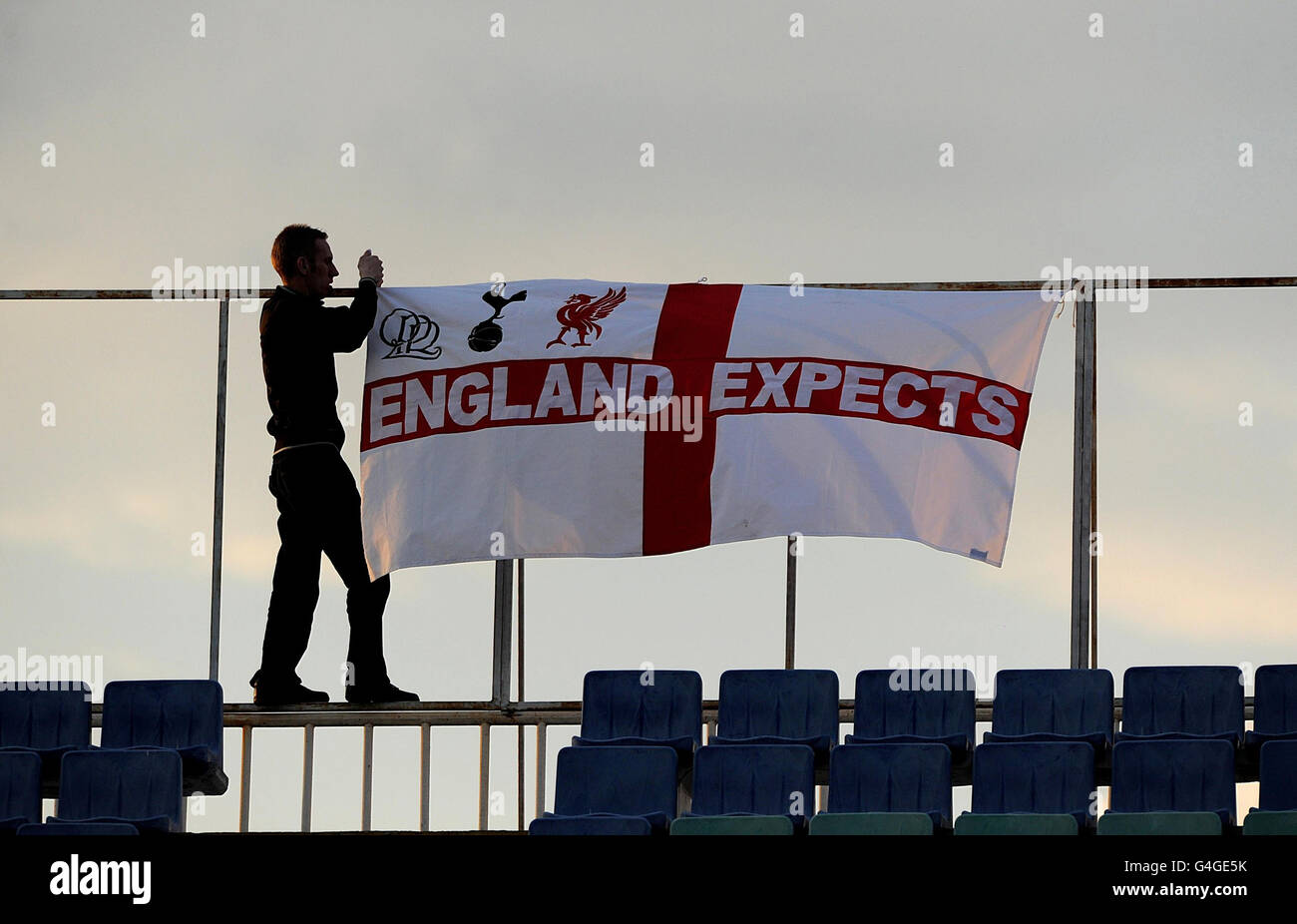 An England fan puts a flag up in the stands before the European ...