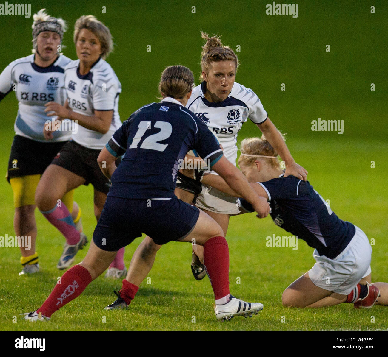 White's Sarah Dixon runs into the tackle from Blue's Lisa Ritchie and ...