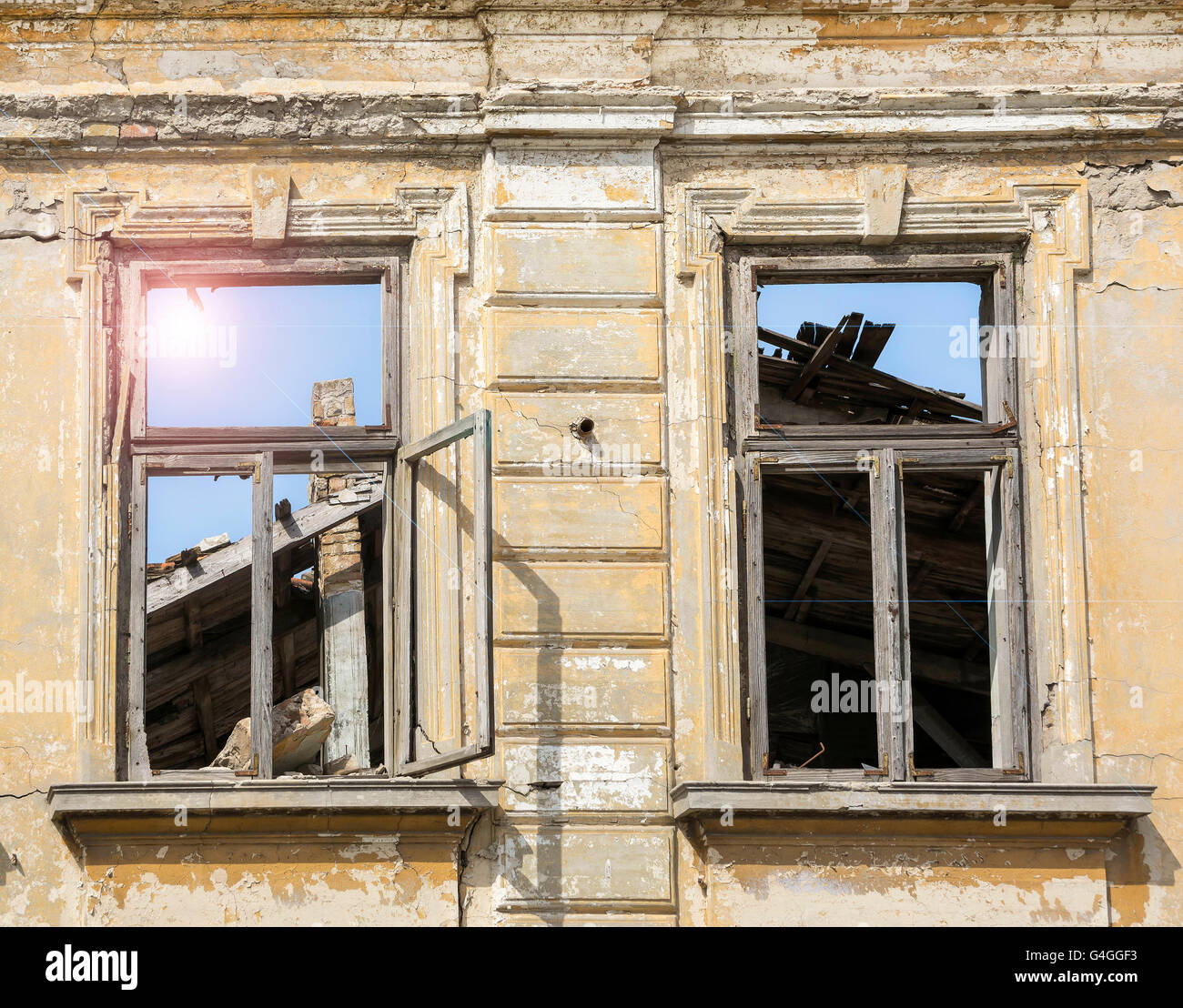 Close up - exterior facade of abandoned house with old wooden windows ...