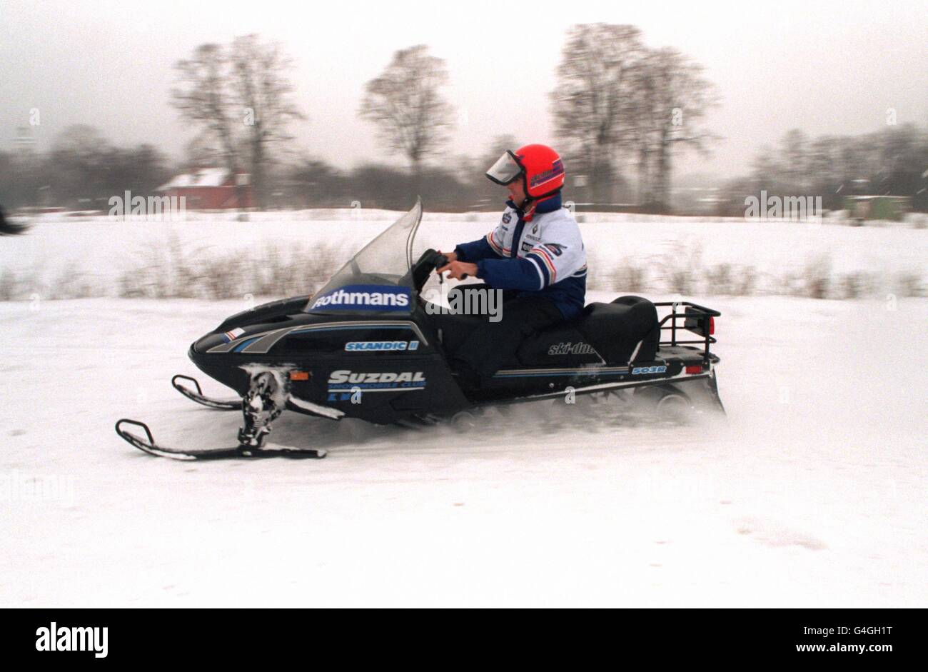 FORMULA ONE DRIVER DAMON HILL RACING A SNOWMOBILE DURING A VISIT TO ...