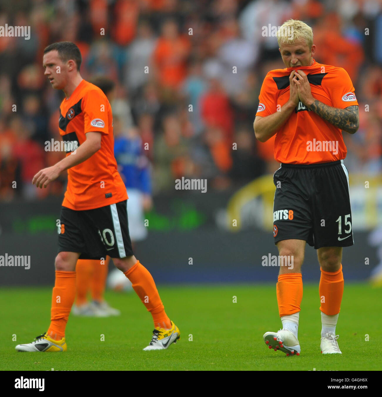 Dundee United's Johnny Russell walks off dejected after being shown the ...