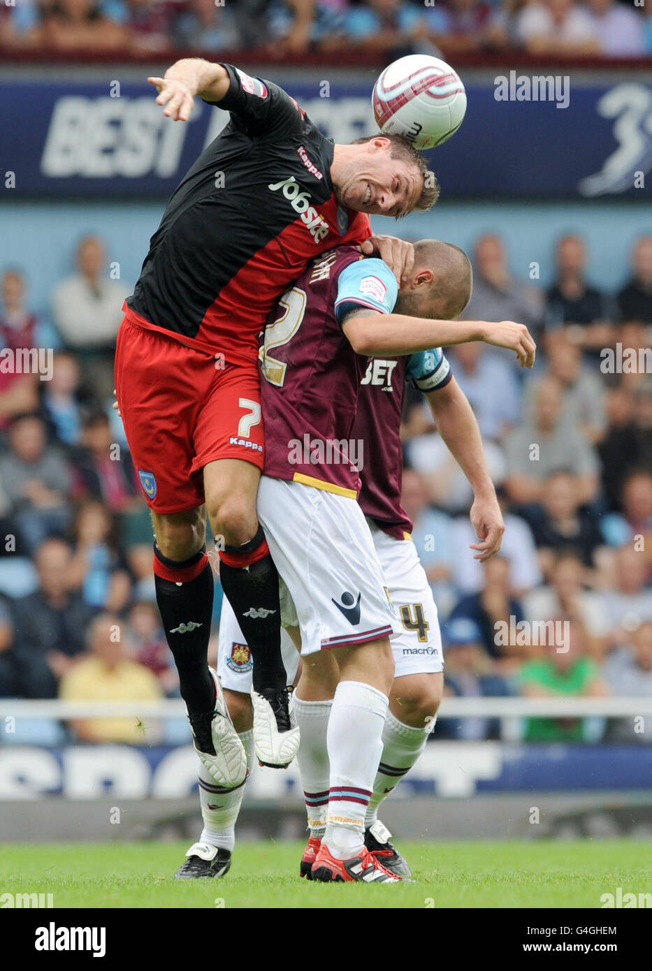 West Ham's Henri Lansbury and Portsmouth's Liam Lawrence (left) compete ...
