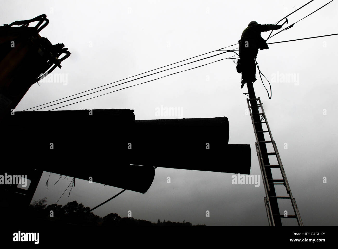 A BT engineer works to replace a fallen telegraph pole on the A811 near ...
