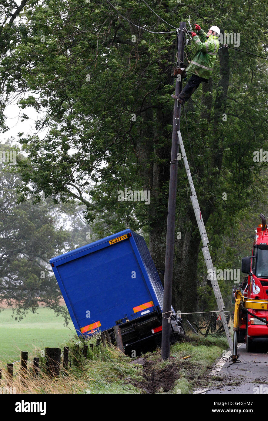 A BT engineer works to replace a fallen telegraph pole on the A811 near ...