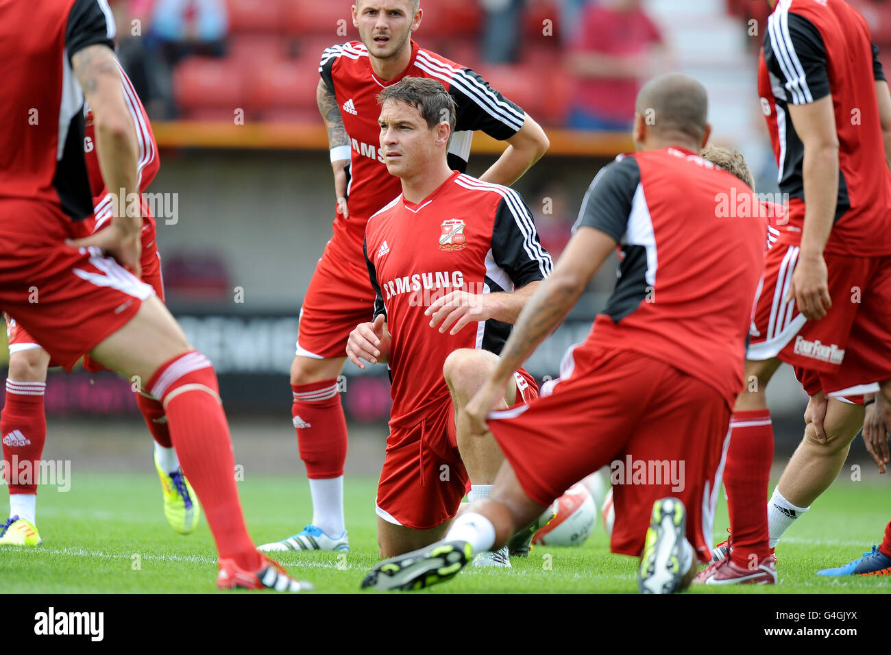 Swindon Town's Oliver Risser (centre) warms up with team-mates Stock ...