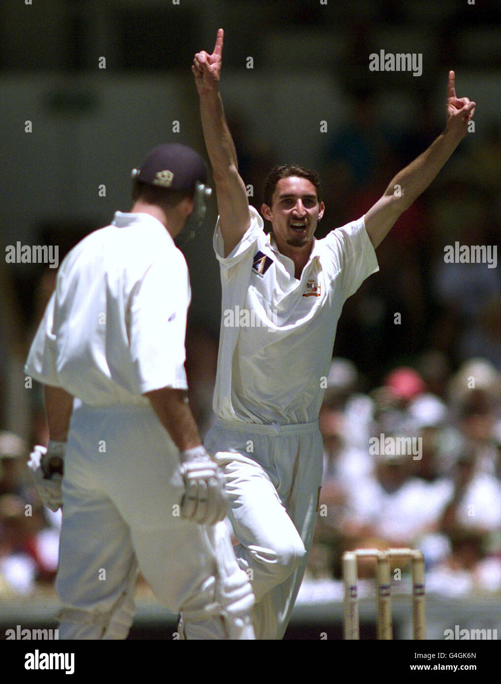 England's new batsman Graeme Hick (left) watches Australia's Jason ...