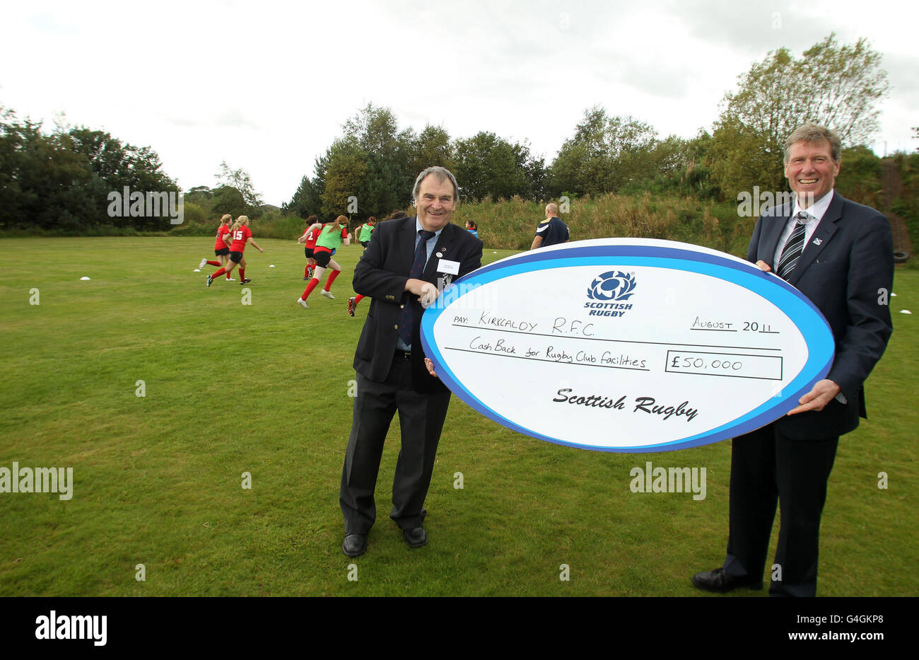 MSP Kenny MacAskill (left) presents a cheque to Don Burns from ...