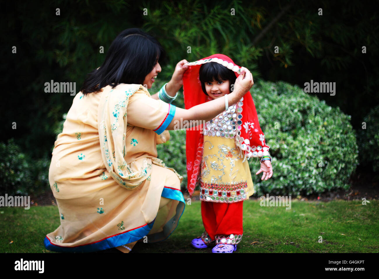 Ambreen Ali fixes the headscarf on her daughter, Isha Ahmed, 2, in the ...