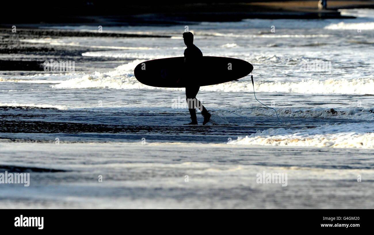 Surfing on Tynemouth beach Stock Photo - Alamy
