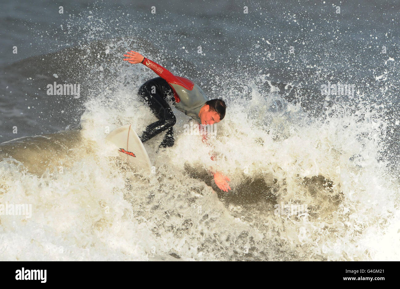 Surfing on Tynemouth beach Stock Photo - Alamy