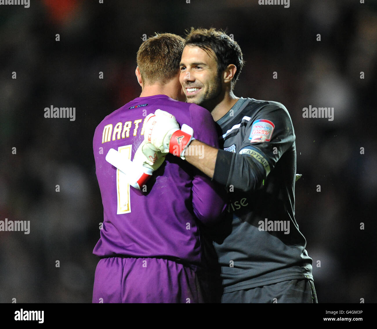Milton Keynes Dons' goalkeeper David Martin (left) congratulates ...