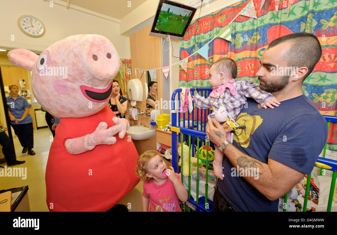 Peppa Pig meets patients Ava and Rosie (being held by her father) at ...
