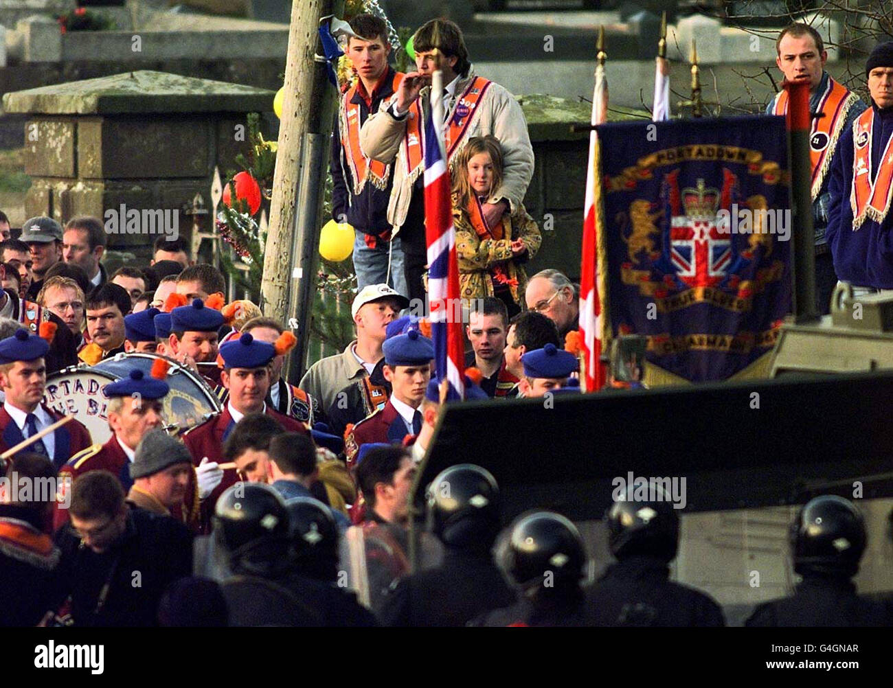 A young Orange Order supporter stands on a wall at Drumcree Church to ...