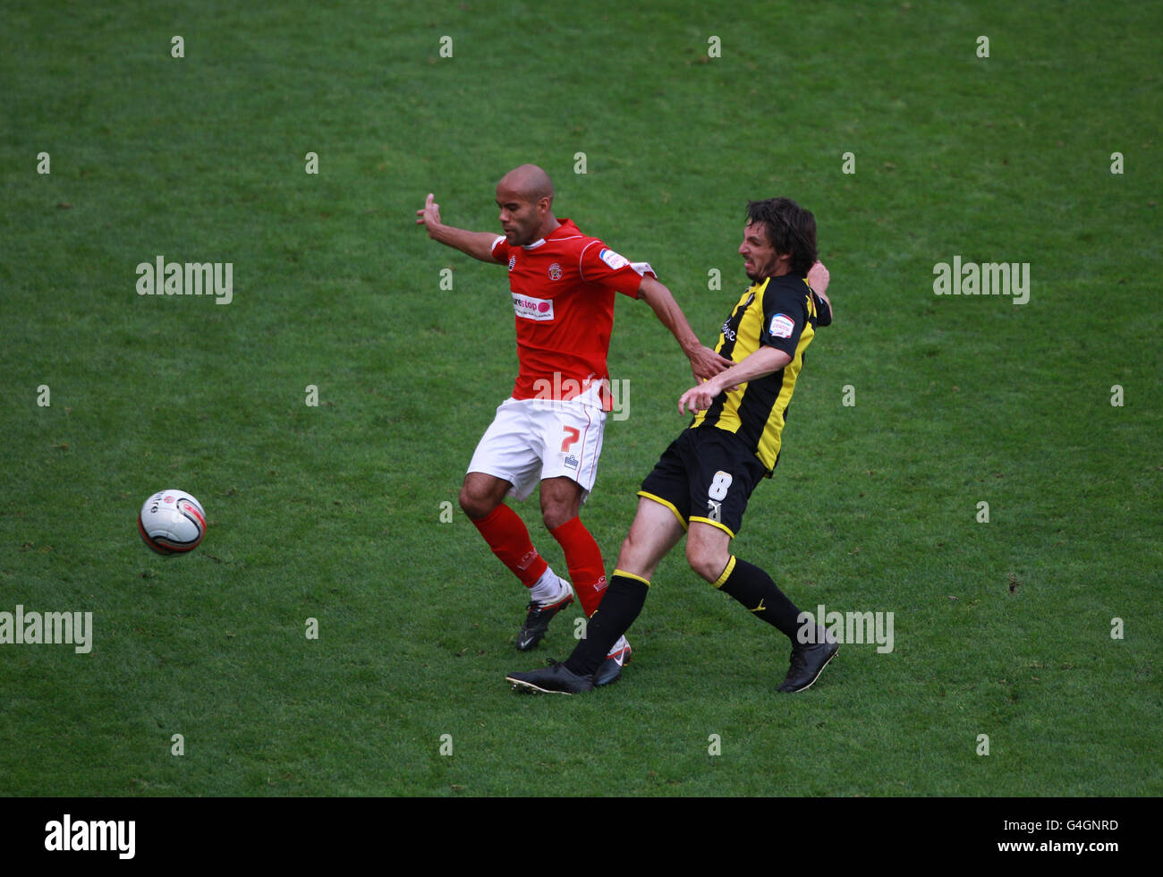 Brentford's Jonathan Douglas holds off challenge from Walsall's Adam ...