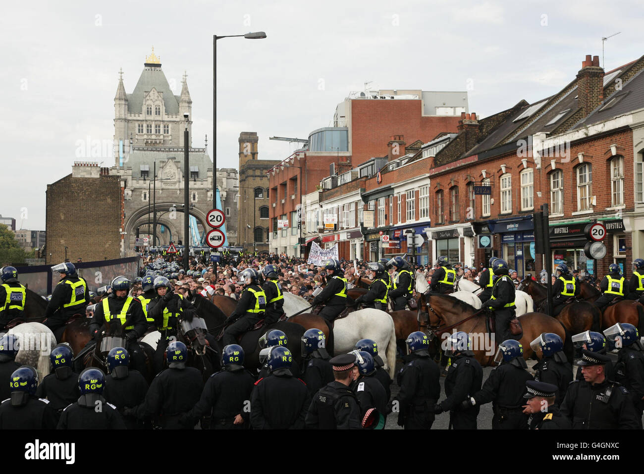 English Defence League (EDL) demonstrators are held by police at Tower ...