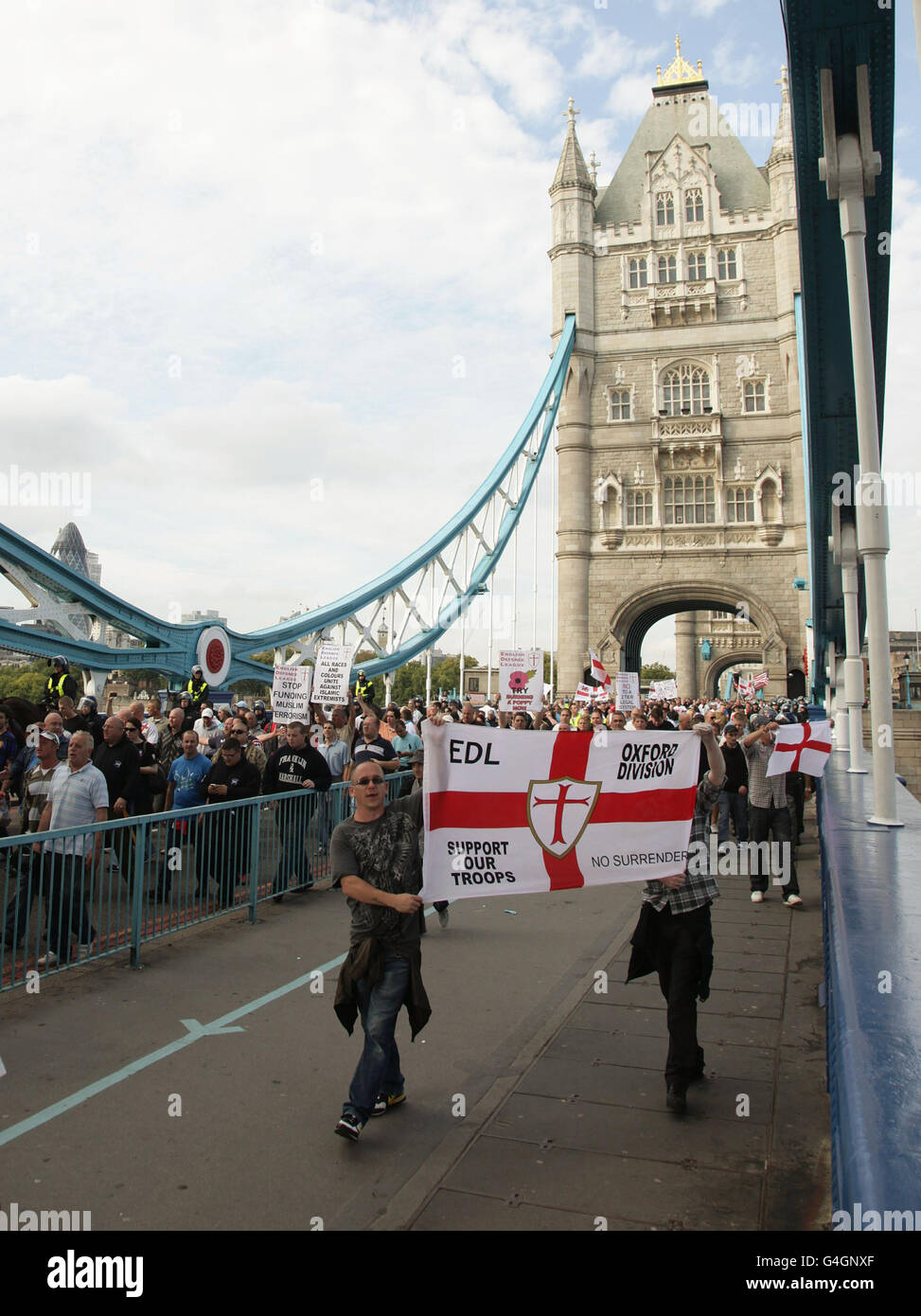 English Defence League (EDL) demonstrators are lead along Tower Bridge ...