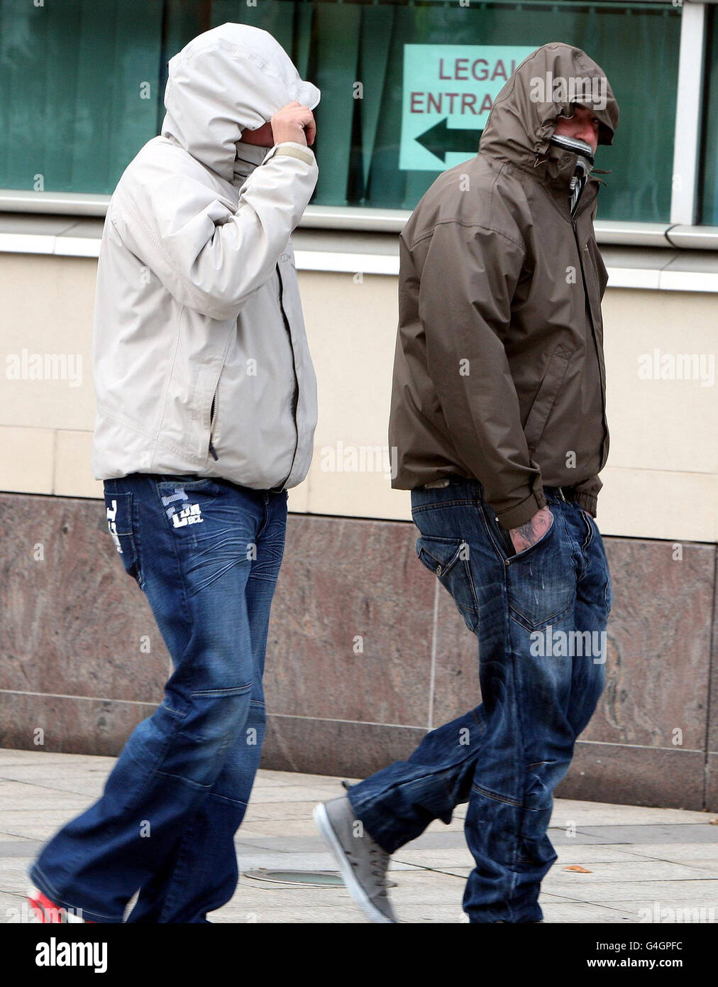 Men conceal their identity as they arrive at Belfast crown court Stock ...