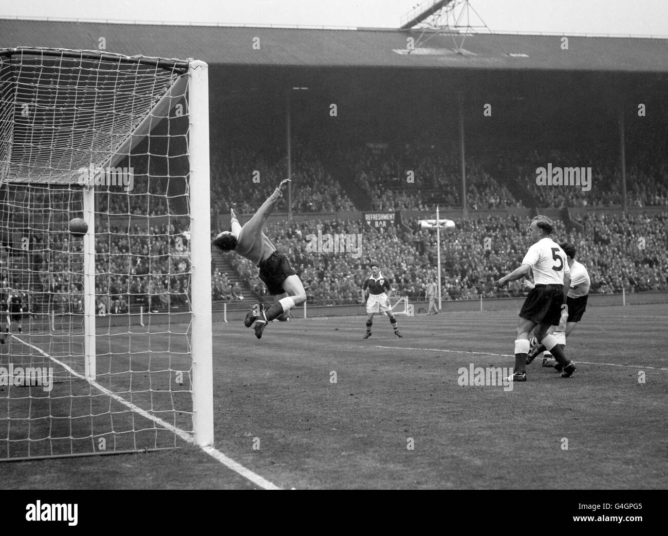 Dermot Curtis (hidden) scores past England goalkeeper Alan Hodgkinson ...