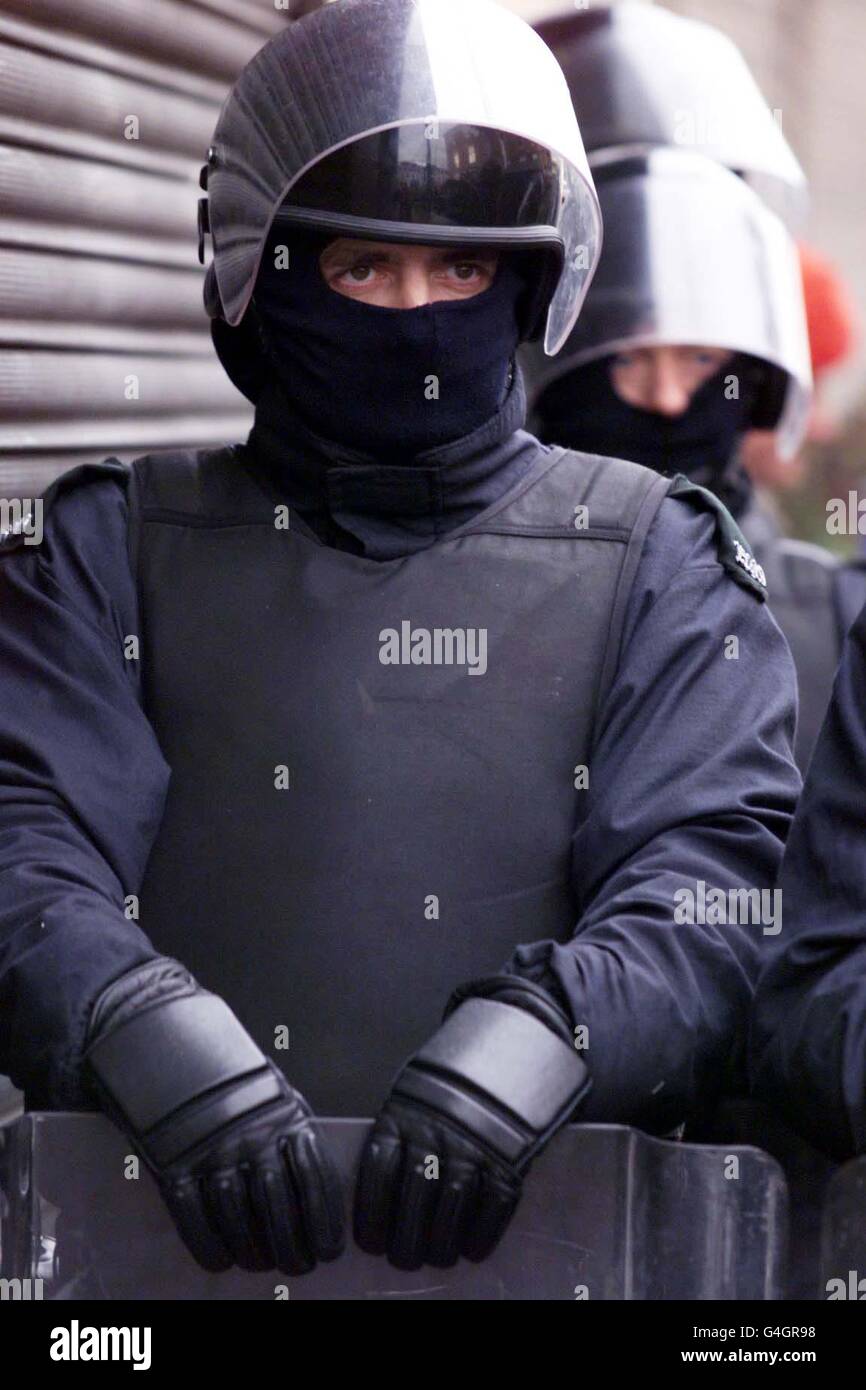 RUC officers in riot gear keeping a watchful eye as hundreds of ...