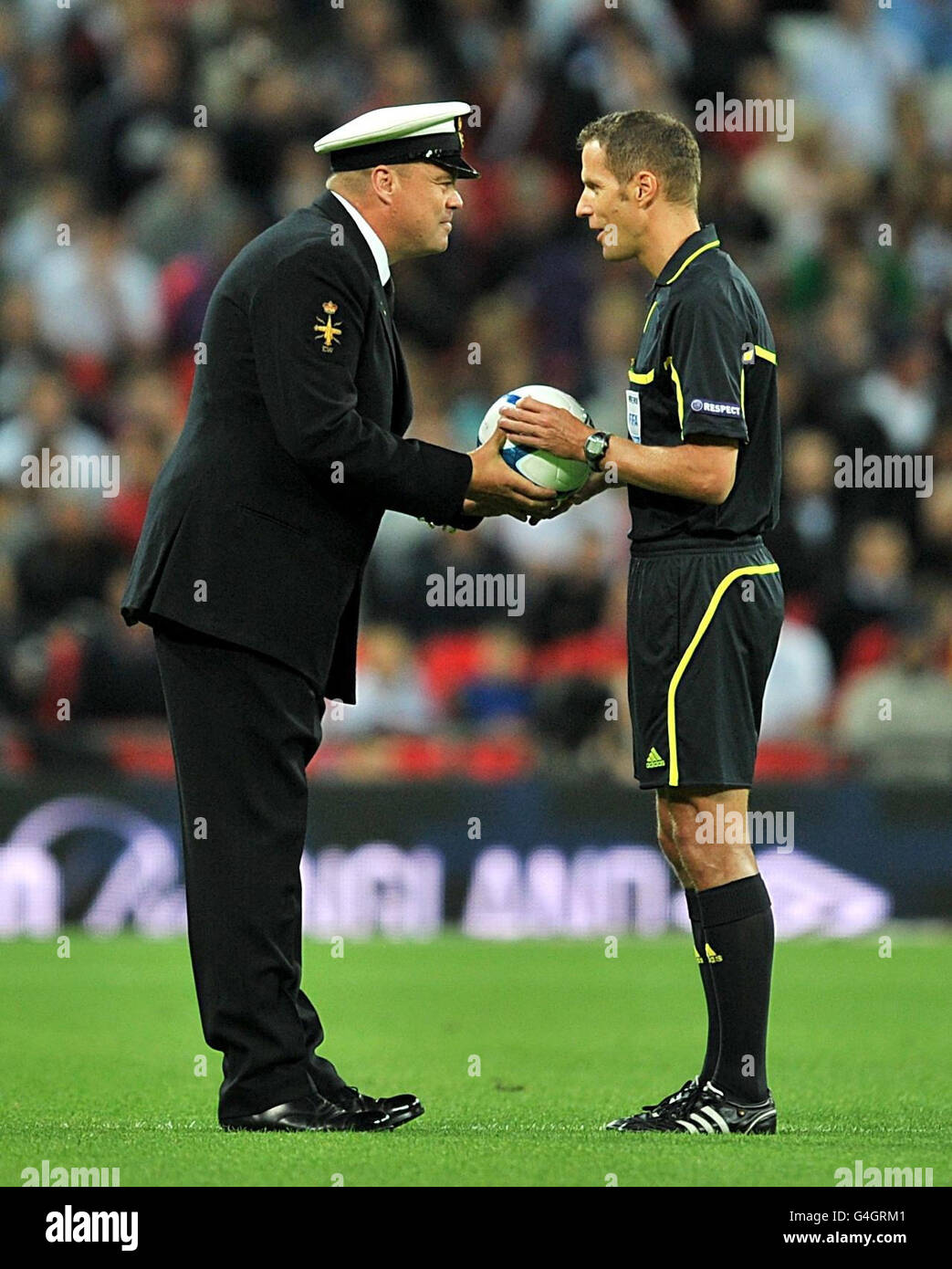 Petty Officer Andy "Gibbo" Gibbs presents the match ball to referee ...