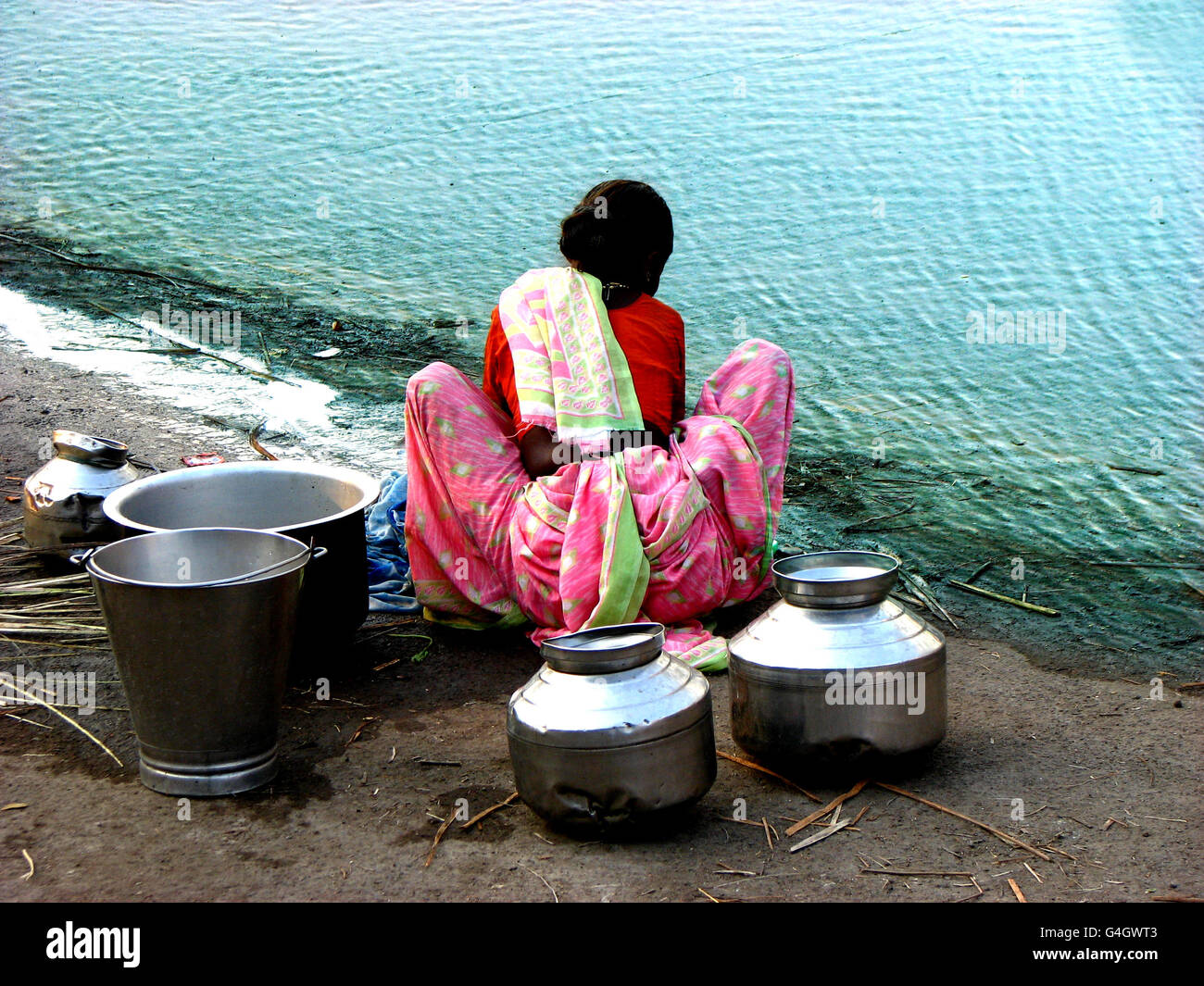 Poor Woman washing vessels Stock Photo - Alamy