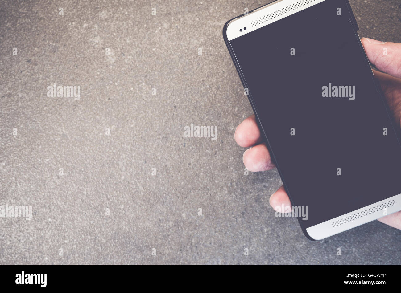 smart phone on a rough stone background - copy space Stock Photo - Alamy