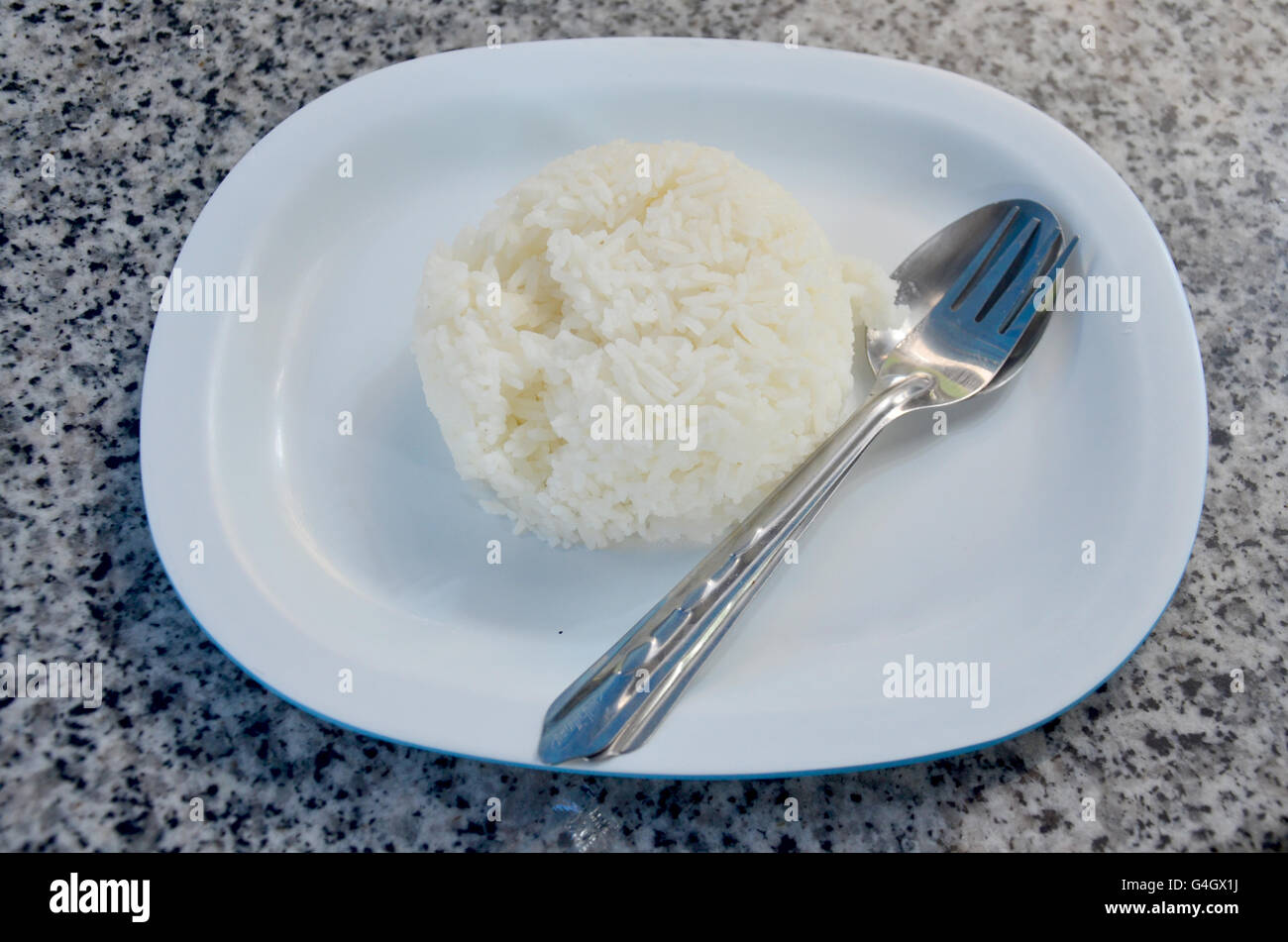 cooked rice thai style on dish with fork and spoon Stock Photo - Alamy