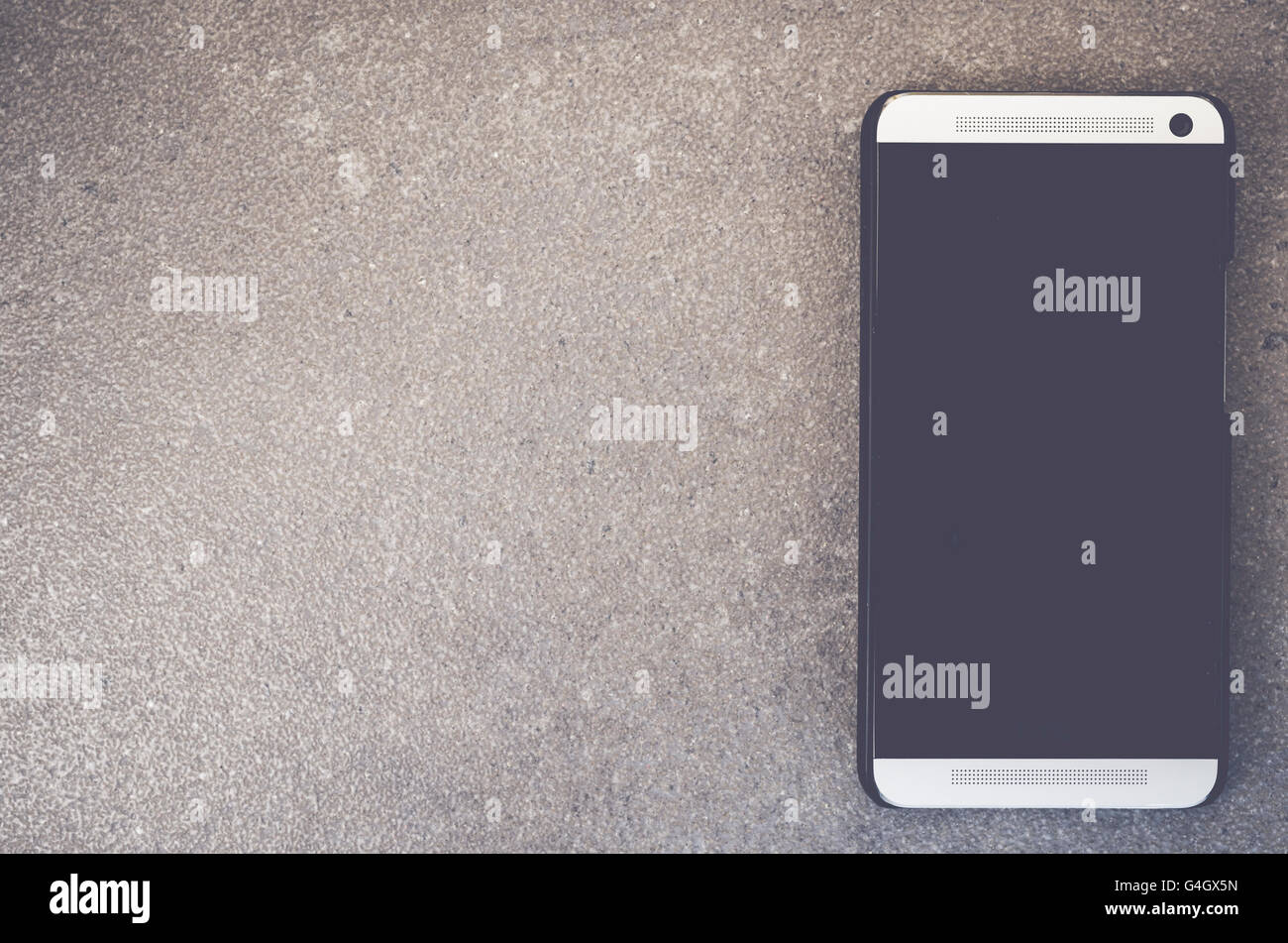 smart phone on a rough stone background - copy space Stock Photo - Alamy