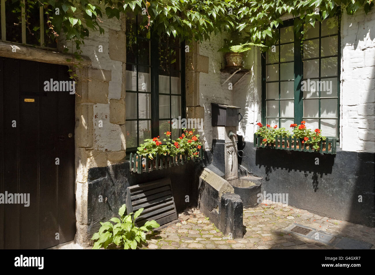 Small medieval alley called Vlaeykensgang in the city centre of Antwerp ...
