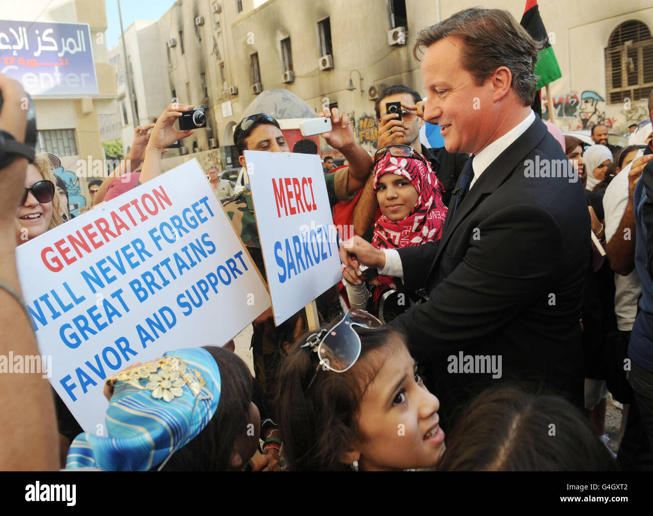 Prime Minister David Cameron meets the locals in Benghazi as he visits ...