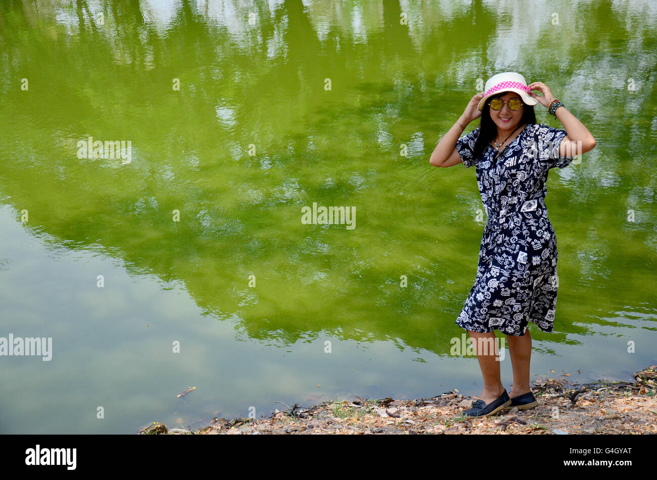 Thai woman portrait at beside natural green swamp or nature green marsh ...