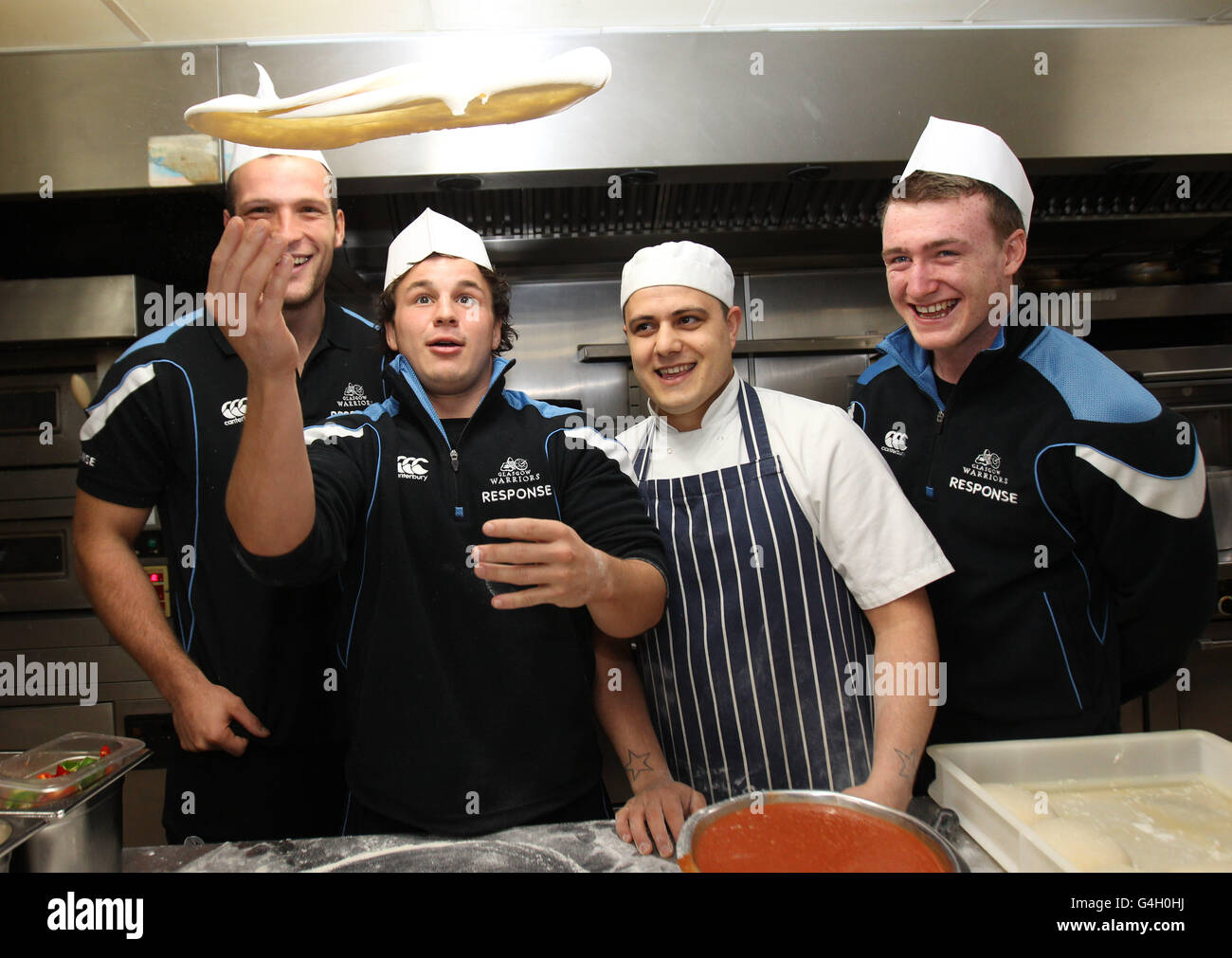 Glasgow Warriors' James Eddie and Stuart Hogg (far right) watch Finlay ...