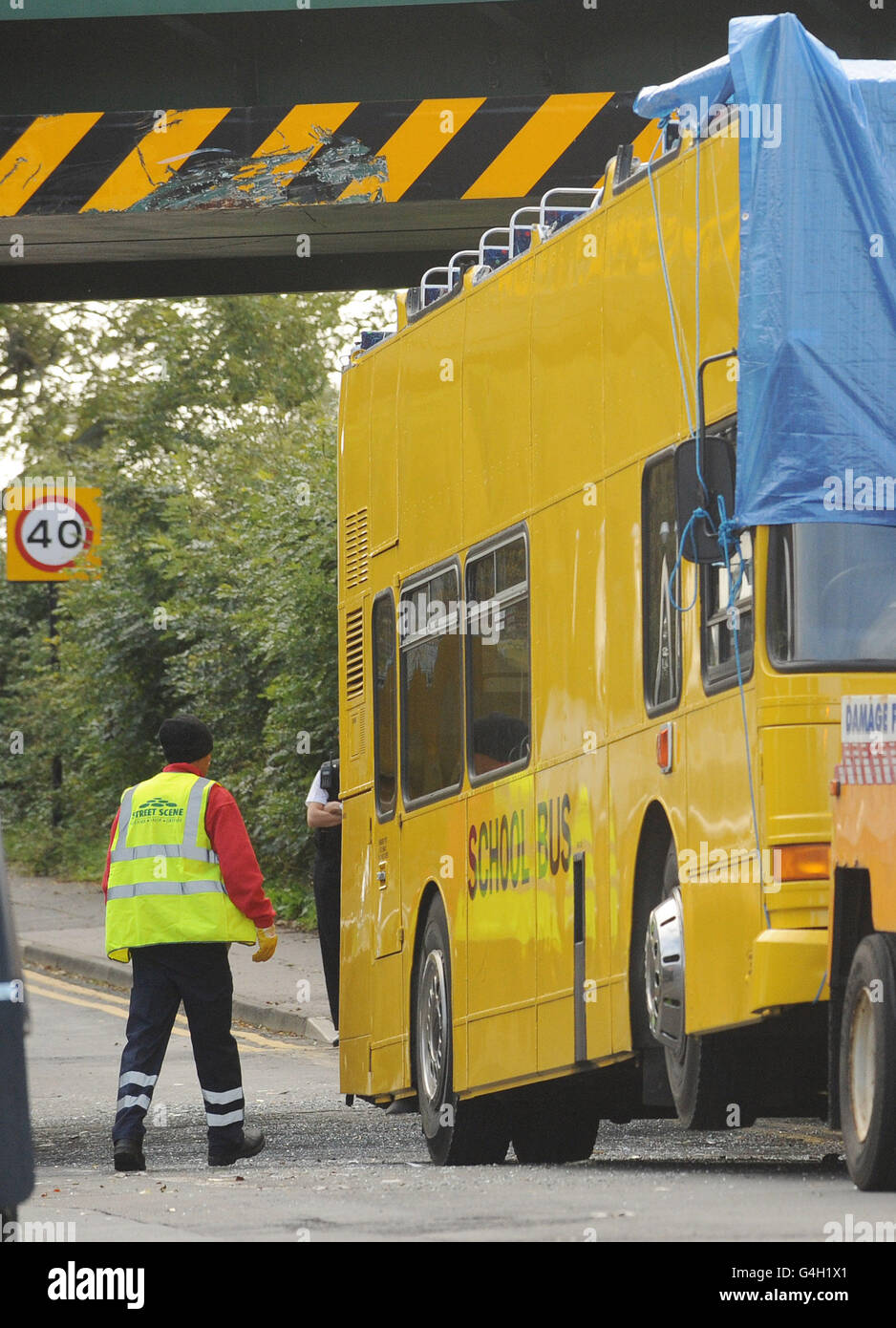 A double decker bus is recovered from underneath a railway bridge in ...