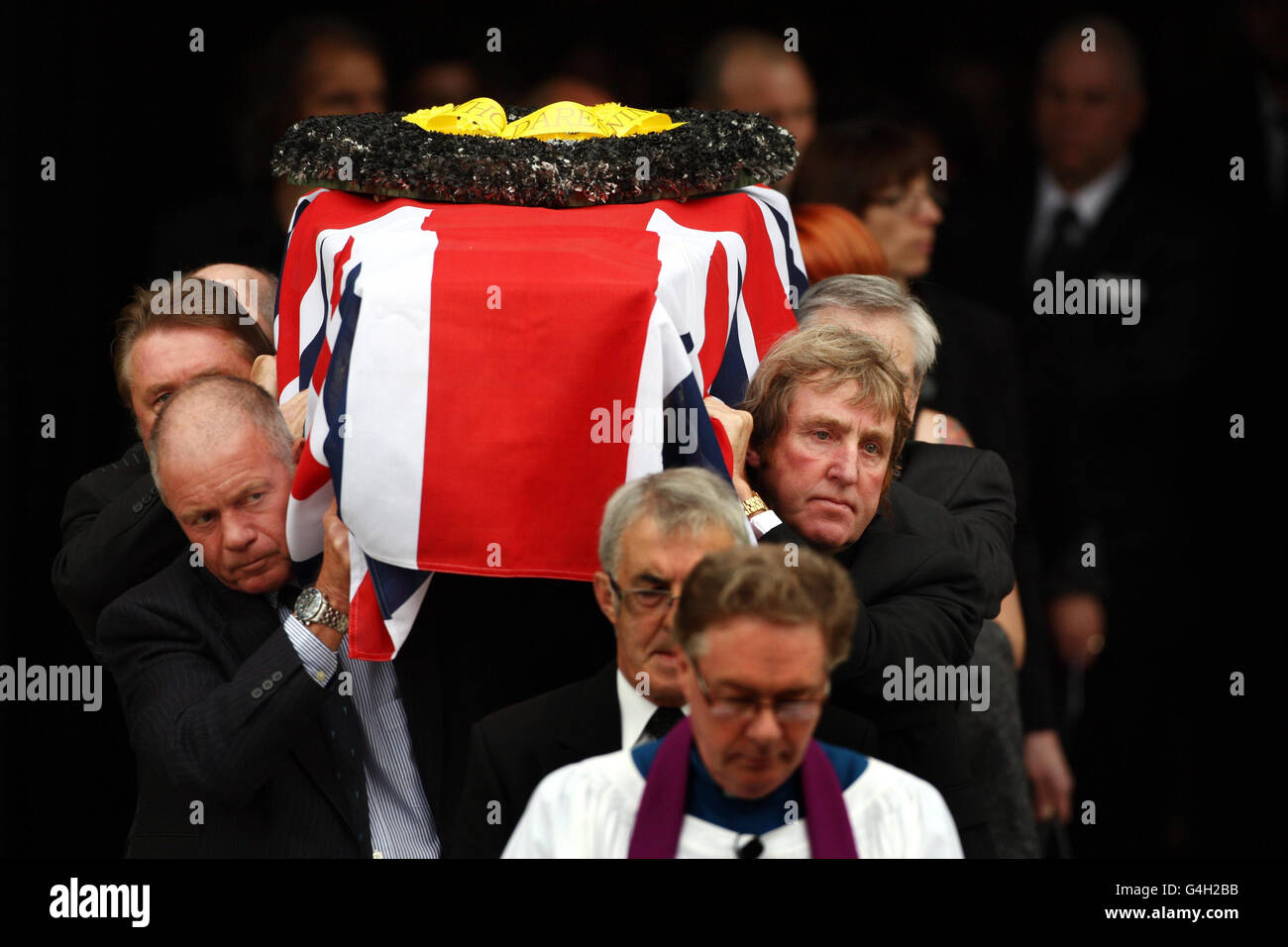Former comrades, including Rusty Firmin (front right) carry the coffin ...
