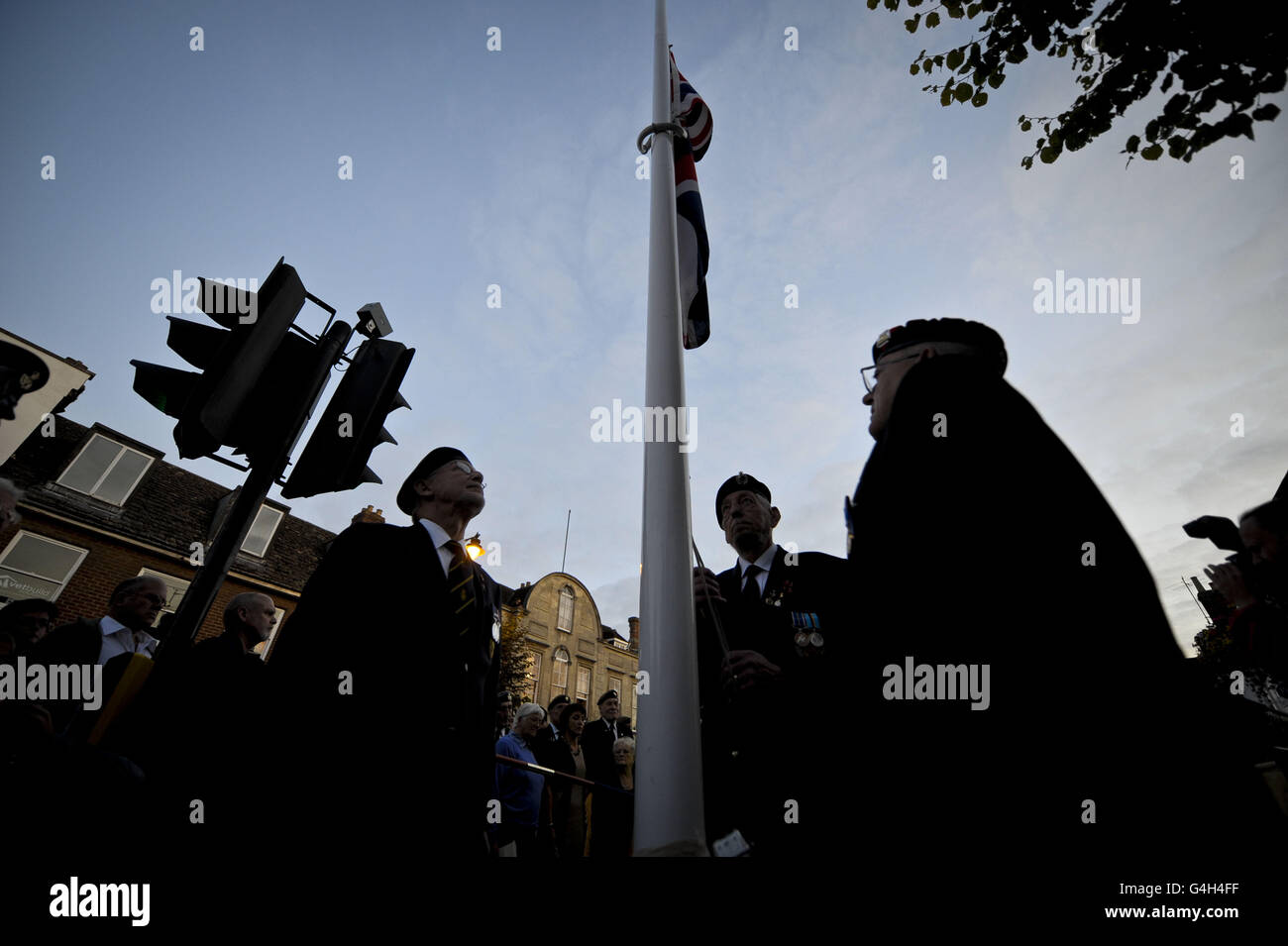 The official flag party stand beneath the Union flag as it is lowered ...