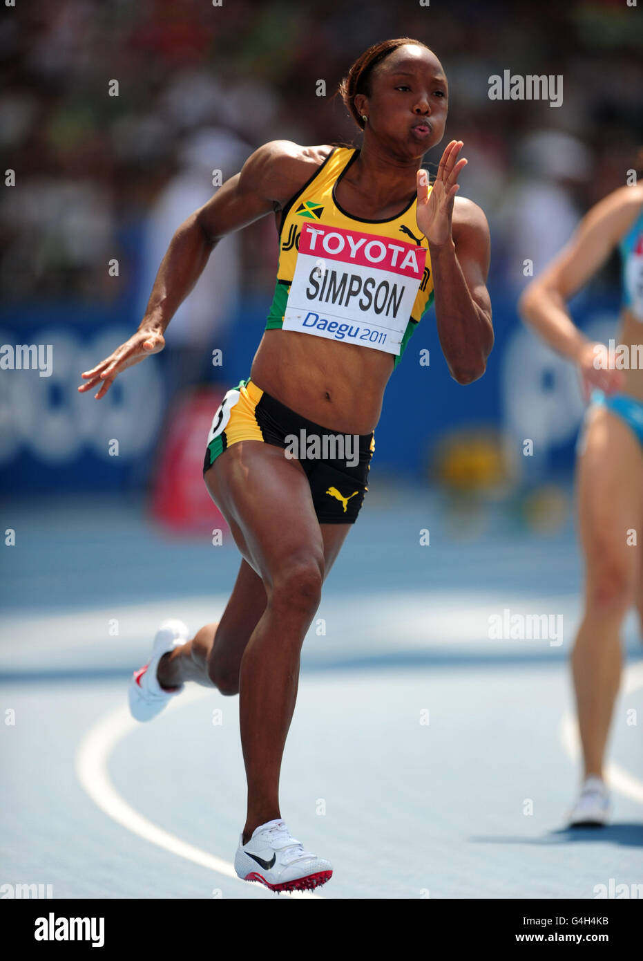 Jamaicas sherone simpson competes in the womens 200m heats hi-res stock ...