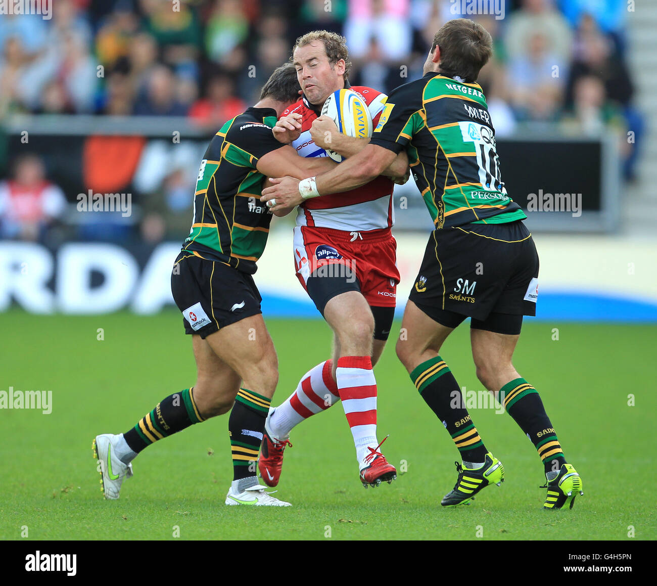 Northampton Saints' Tom May and Stephen Myler tackle Gloucester Rugby's ...