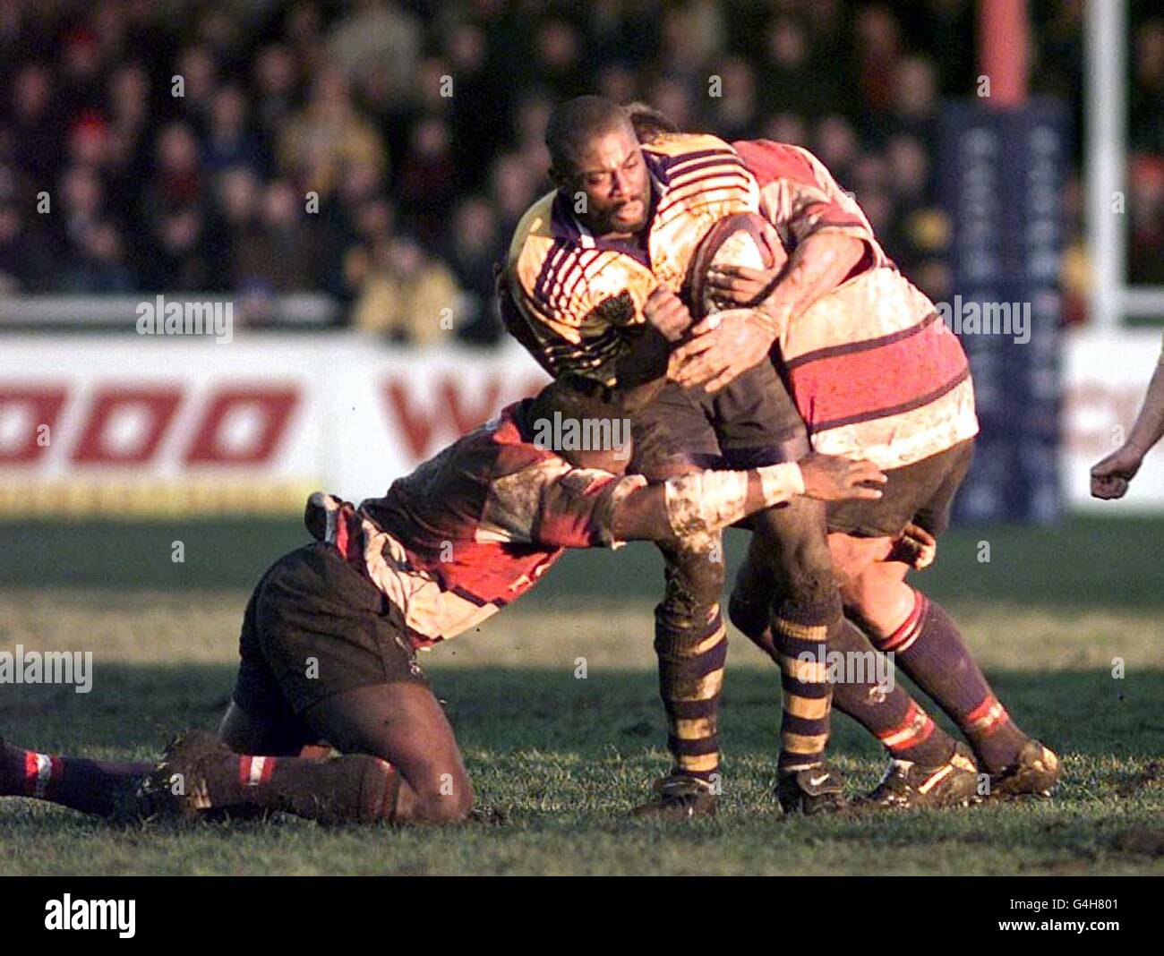 Worcester's Nick Baxter (centre) is tackled by Gloucester defenders ...