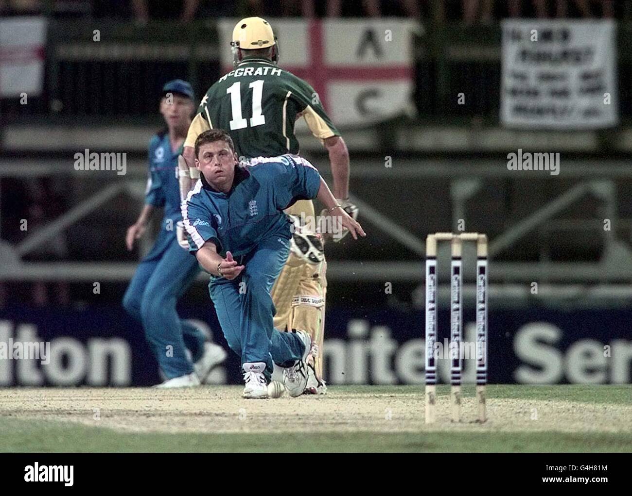 England bowler Darren Gough throws the ball in an unsuccessful attempt ...