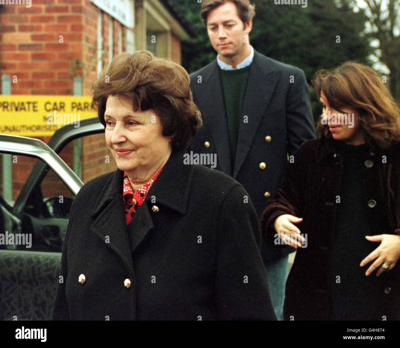 Pinochet relations leave church 2 Stock Photo - Alamy