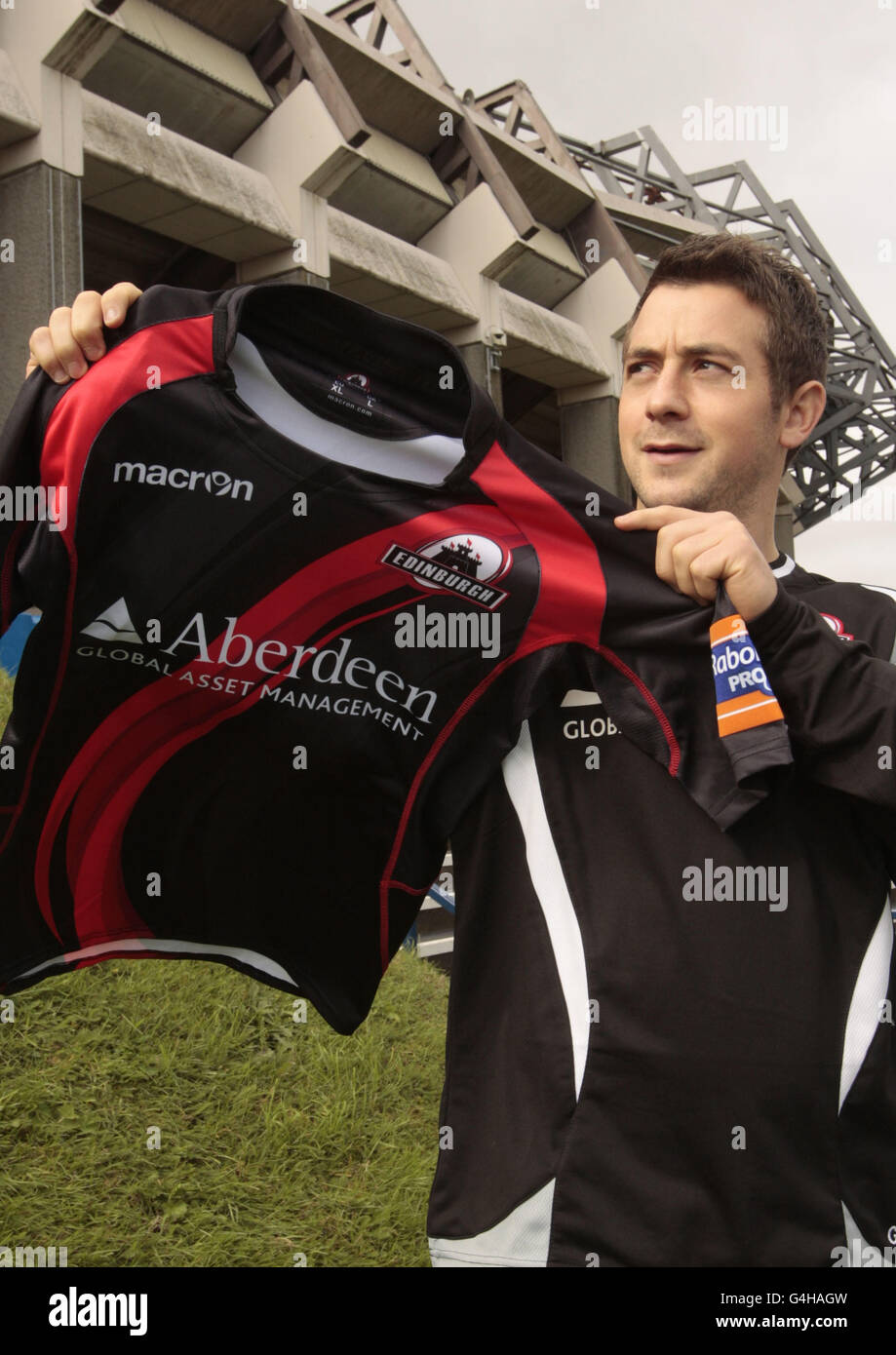 Edinburgh Captain Greig Laidlaw holds up his shirt after signing a two ...
