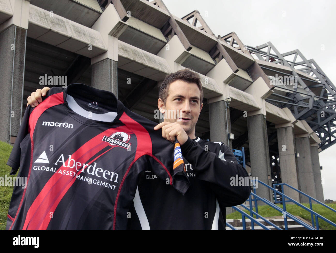 Edinburgh Captain Greig Laidlaw holds up his shirt after signing a two ...