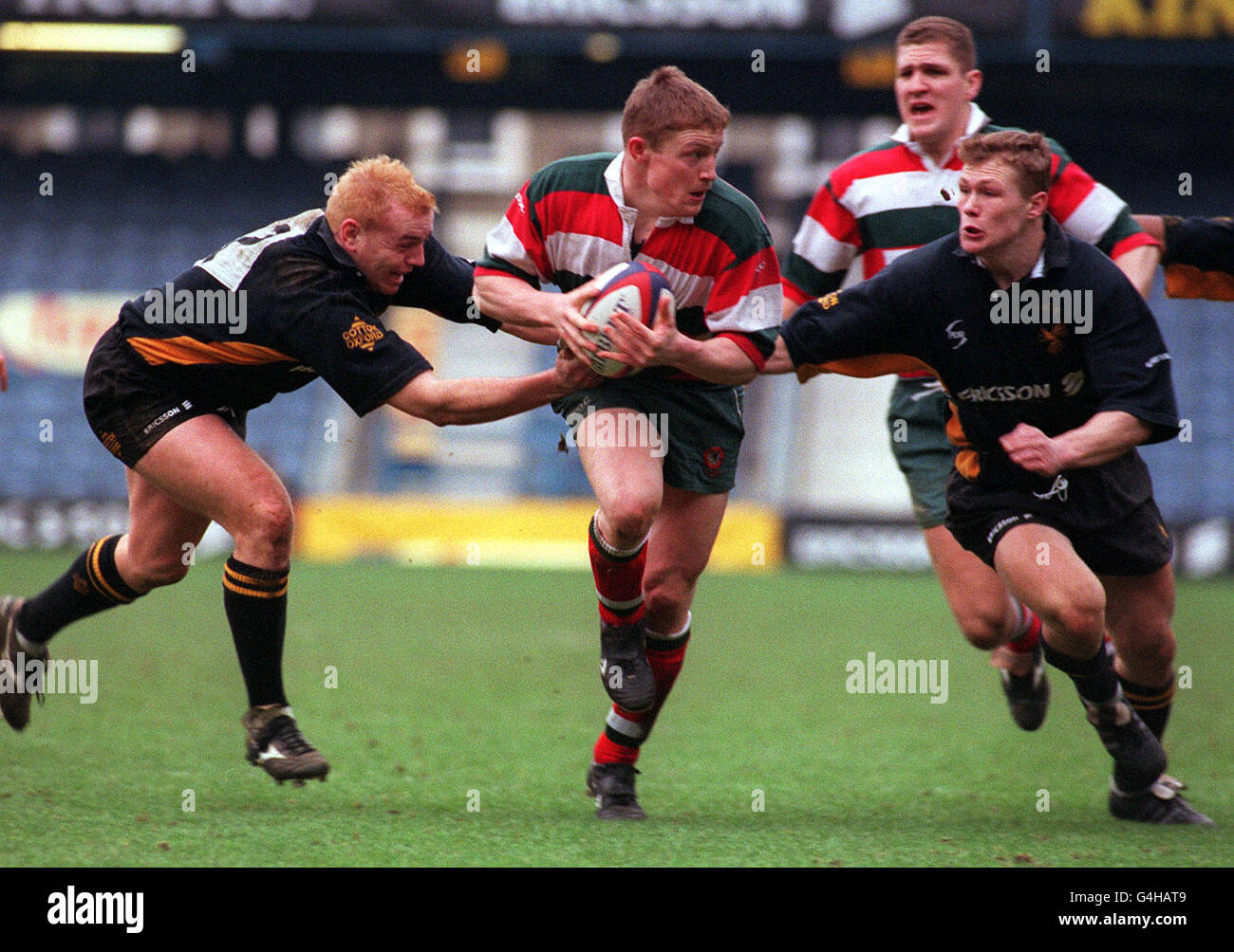 Phil Graham of Waterloo (centre with ball) tries to escape from the ...