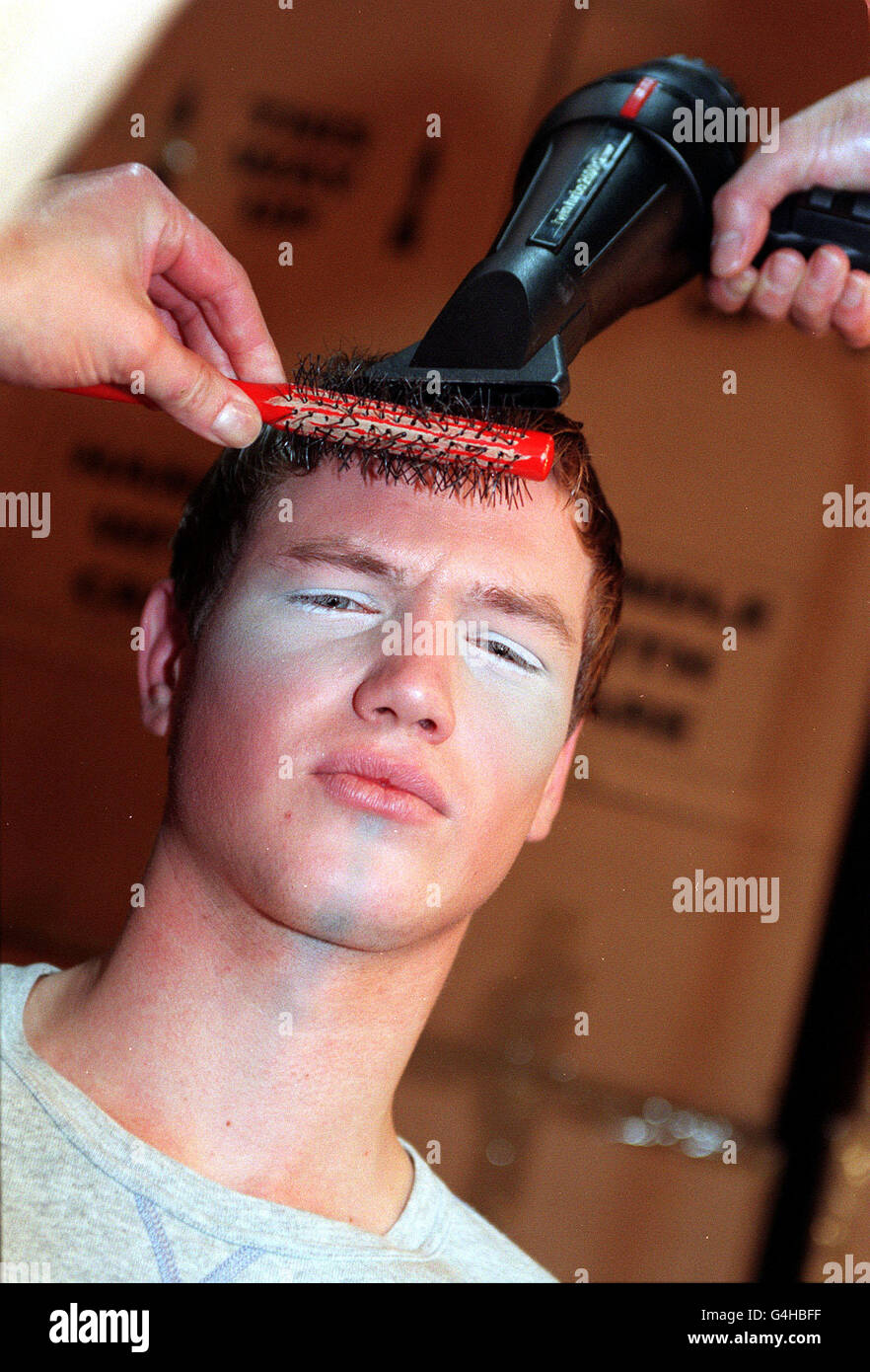 A model has his hair prepared before the presentation of the 'Psyche ...